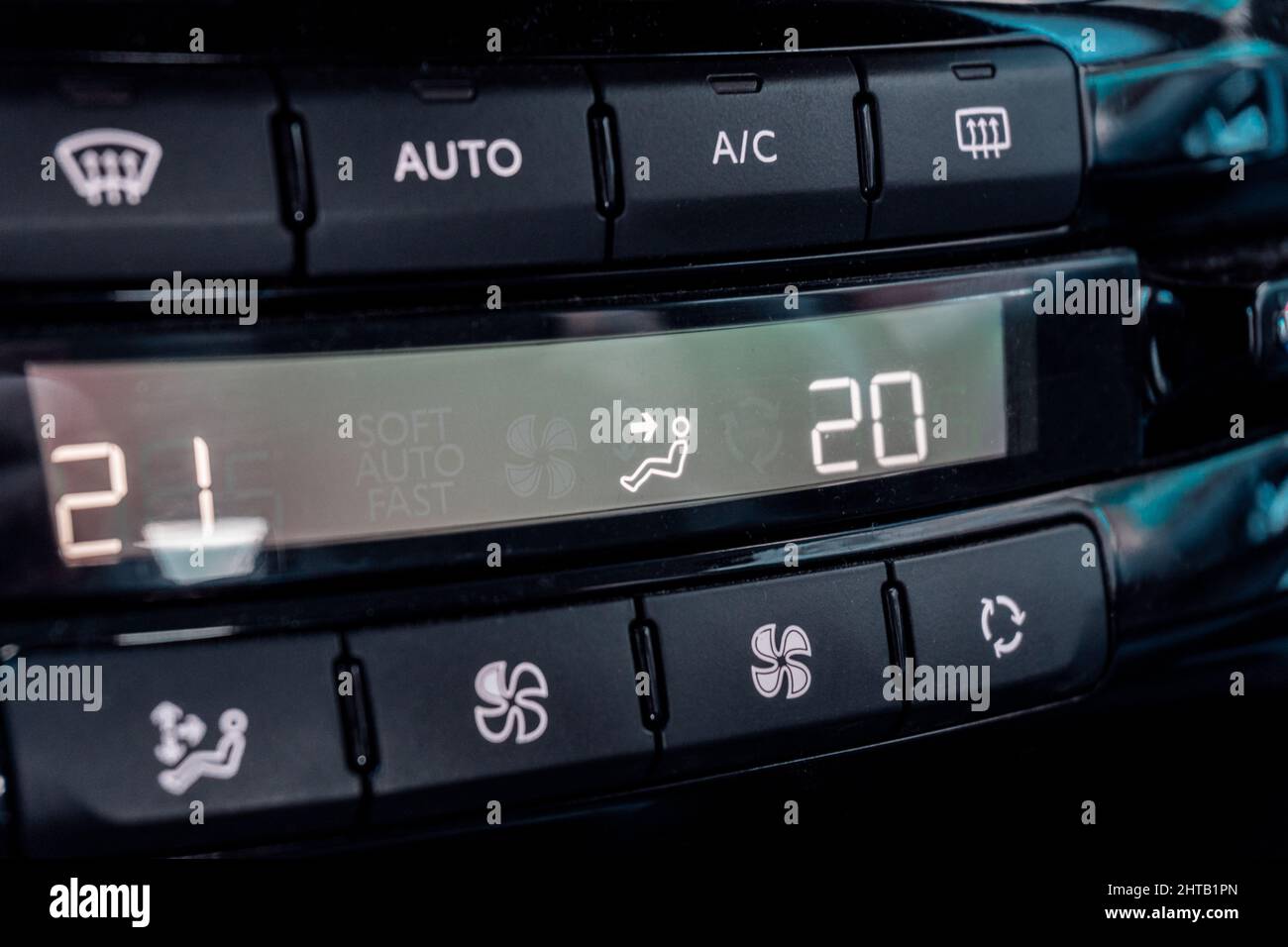 Detailed closeup of the buttons and screen of a car's climate control ...