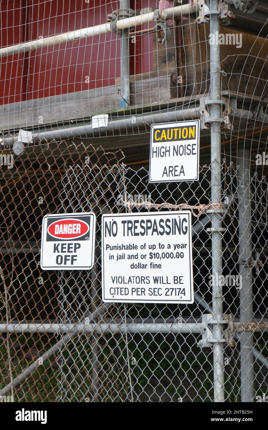 Vertical shot of the no trespassing sign on the net fence Stock Photo ...