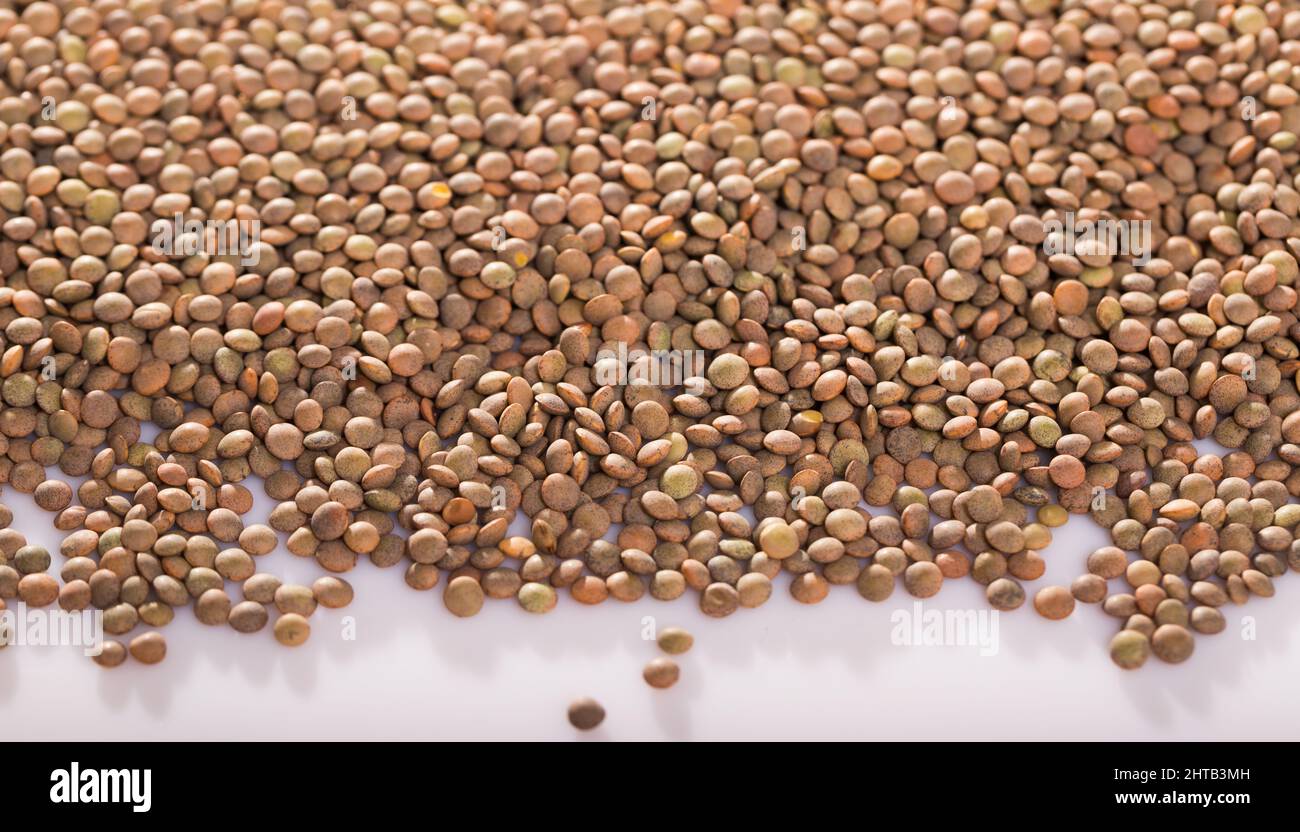Lentils on white surface Stock Photo - Alamy
