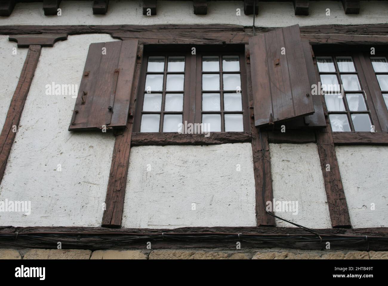 Low angle shot of the open windows of an old building in Hondarribia ...