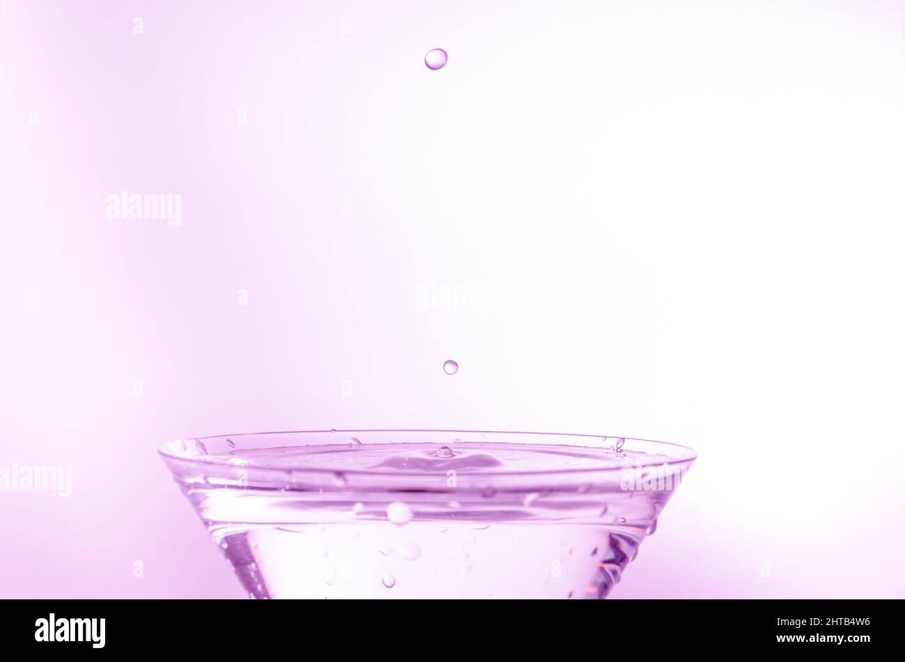 Closeup of water droplets falling into a cup Stock Photo - Alamy