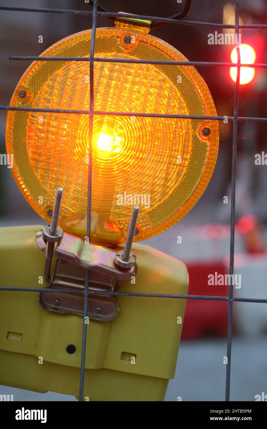 Vertical shot of a yellow warning light on the blurry background Stock ...