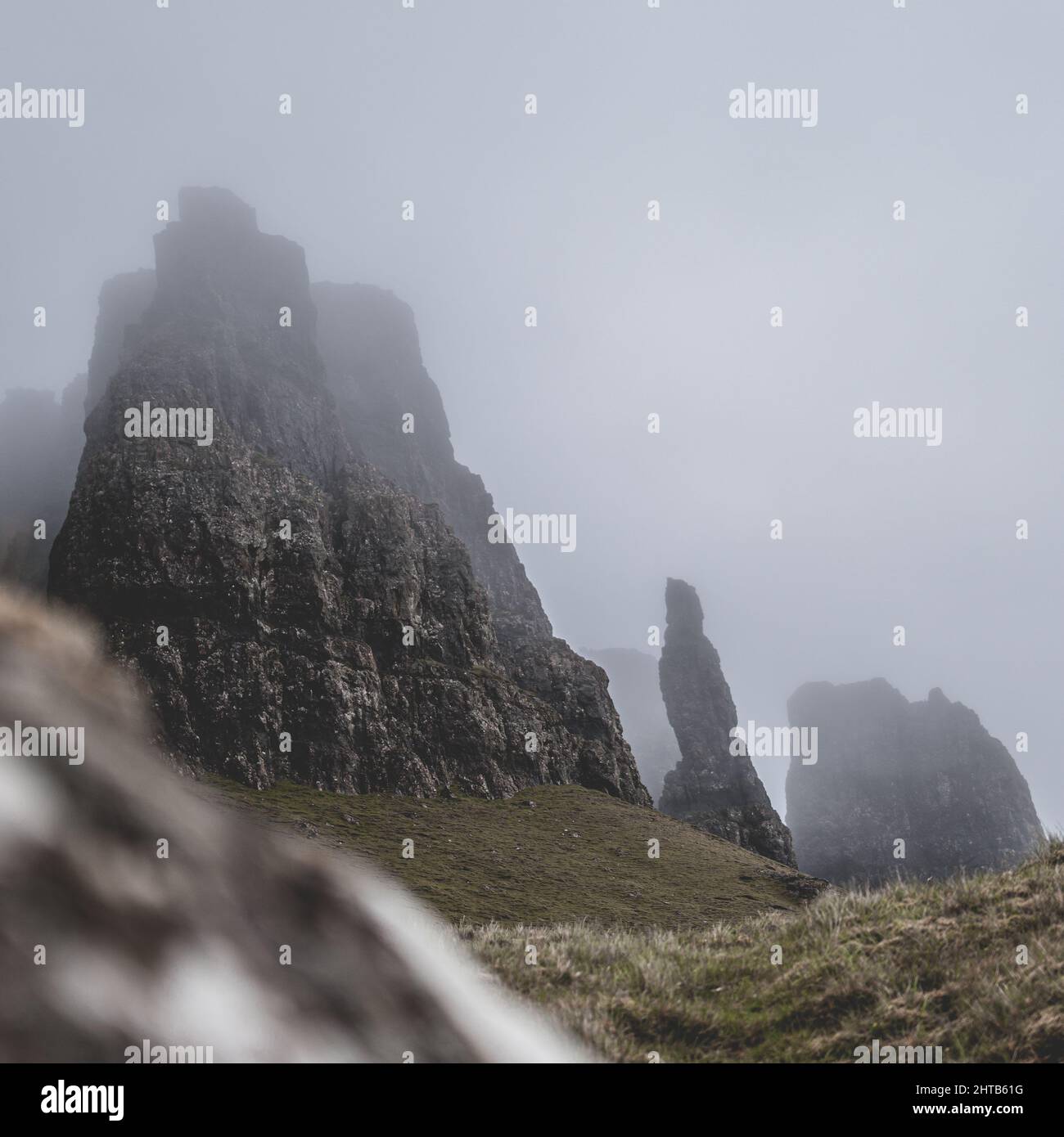 Scenic portrait of foggy rock formations in the Isle of Skye in the ...