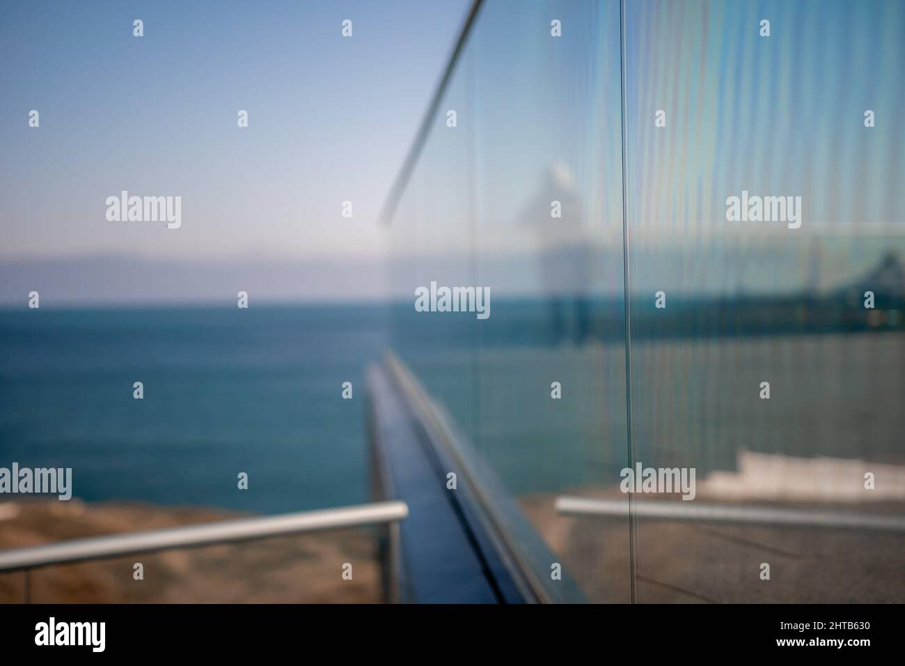 Abstract selective focus glass fence in the seaside park. a popular ...