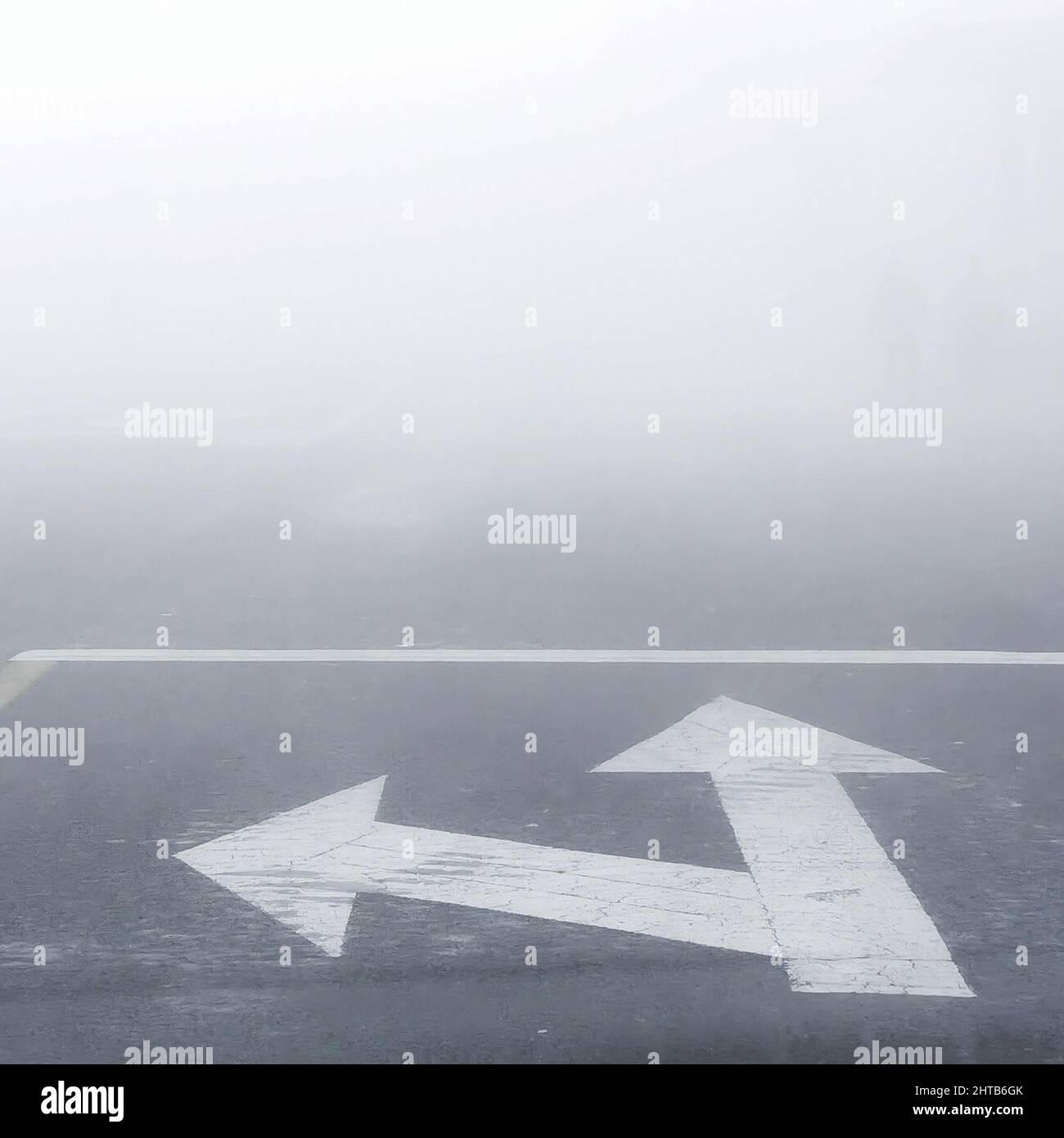 Closeup of foggy arrow signs on the ground Stock Photo - Alamy