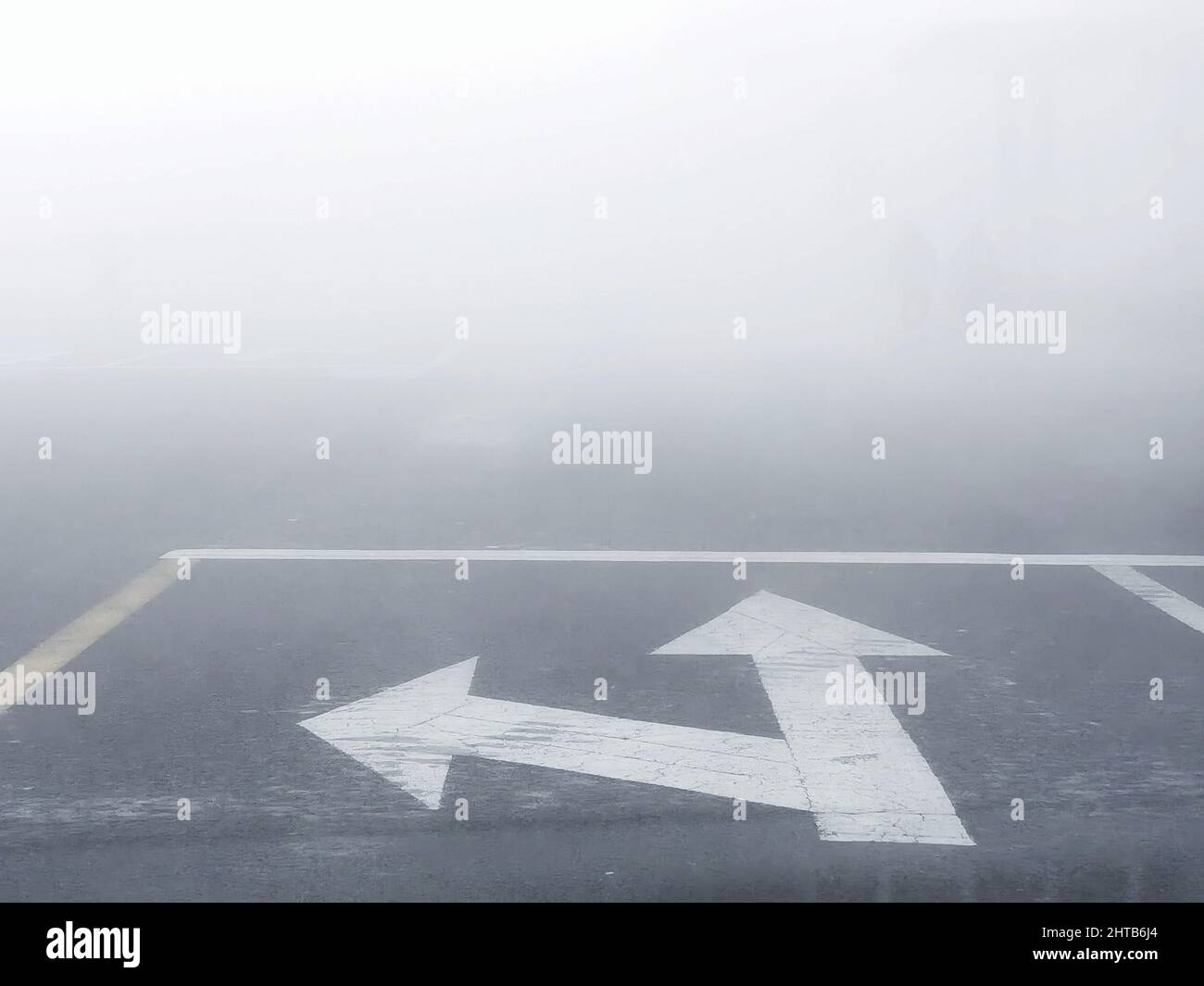 Closeup of foggy arrow signs on the ground Stock Photo - Alamy