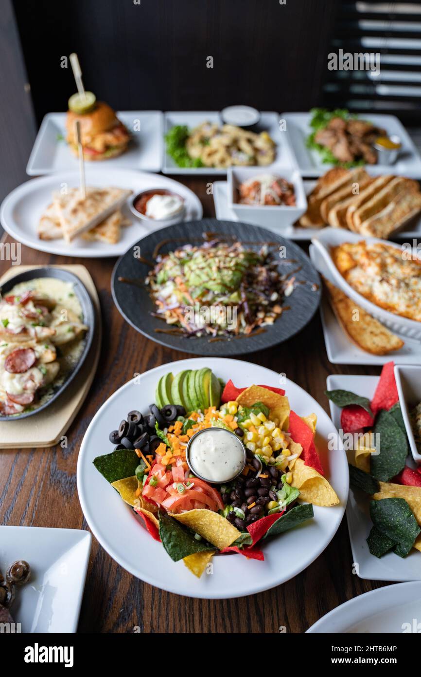 Vertical shot of delicious dinner table with salads and nachos Stock ...