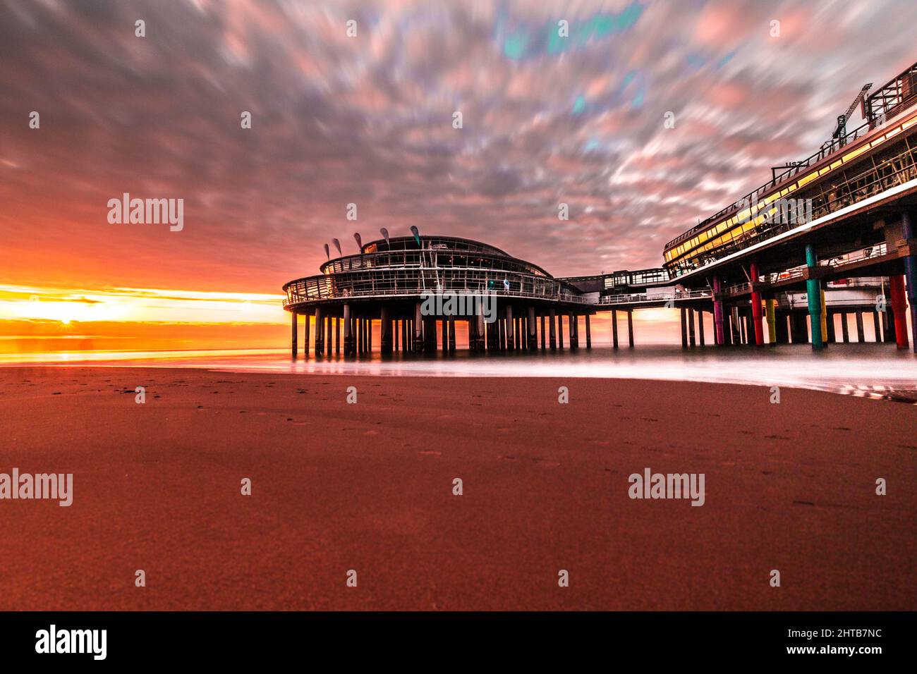 Beautiful view of a sunset over the pier with beautiful building on it ...