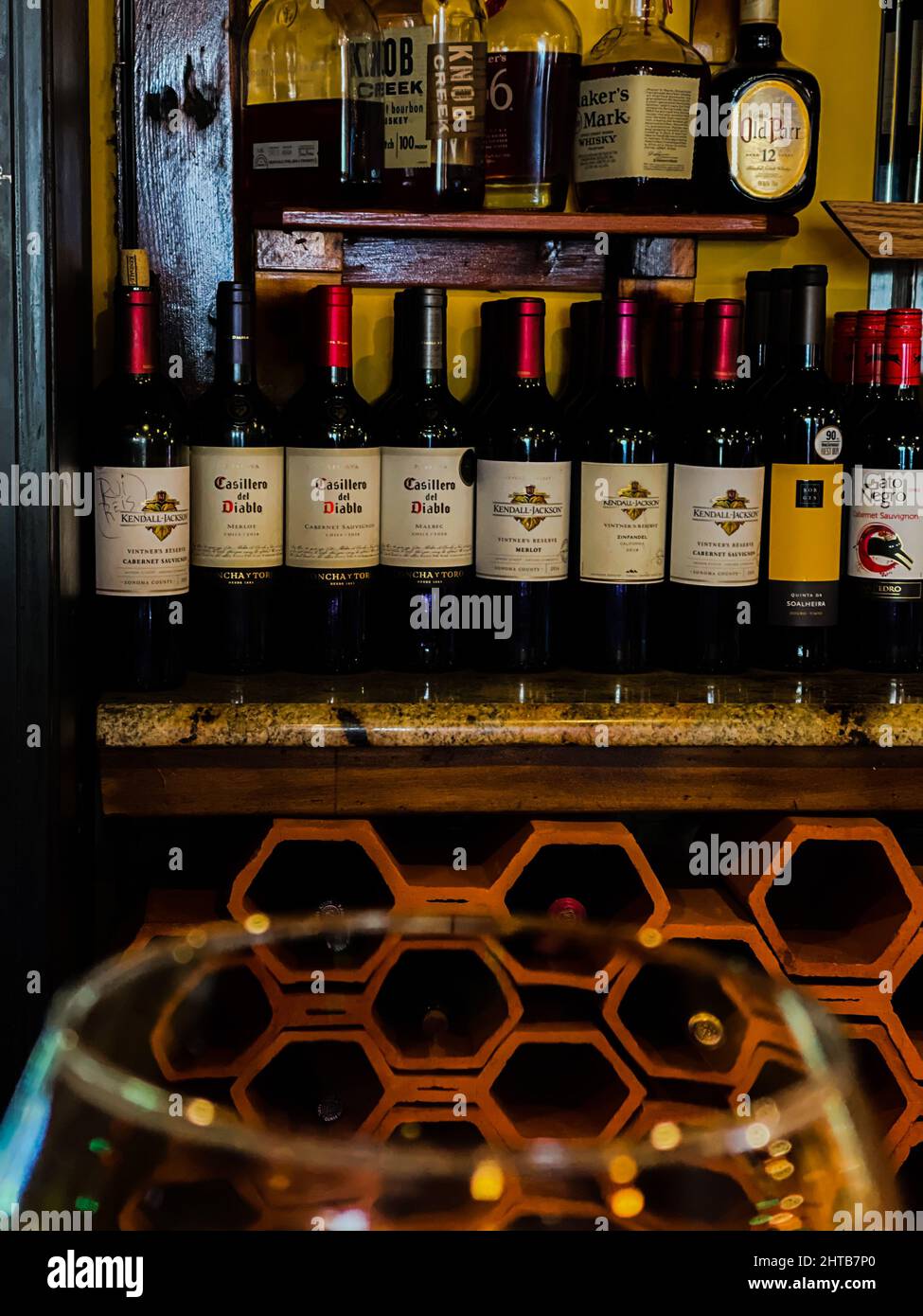 Line of wine bottles in a bar Stock Photo - Alamy