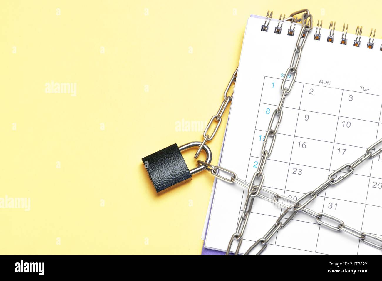 Calendar is wrapped in a chain and closed with a padlock. Yellow ...