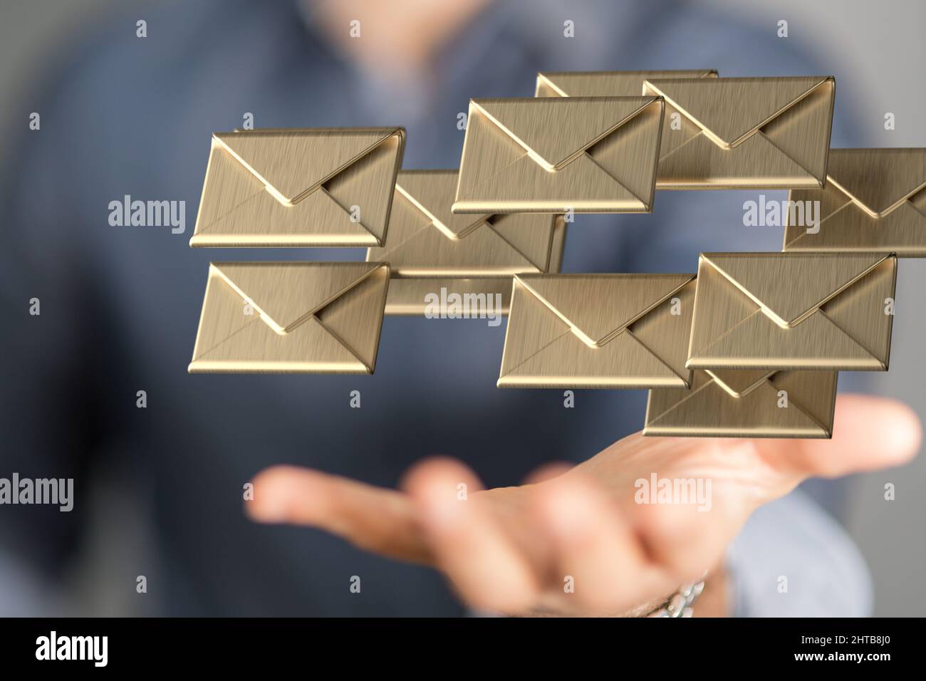 3D rendering of shiny gold email icons in the air with a man holding ...