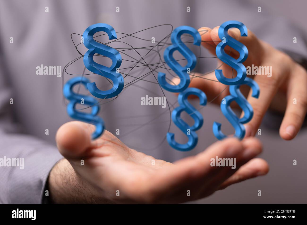 Shallow focus shot of human hands holding law paragraph icons Stock ...