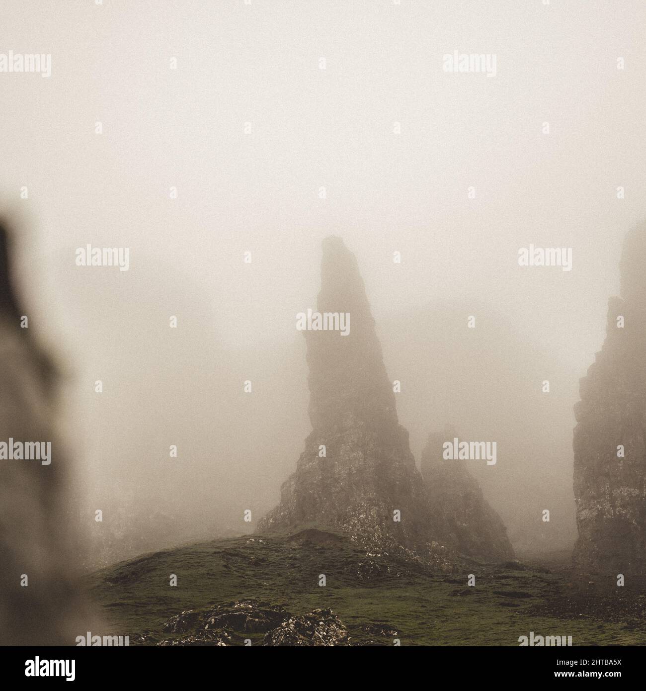 Scenic portrait of foggy rock formations in the Isle of Skye in the ...