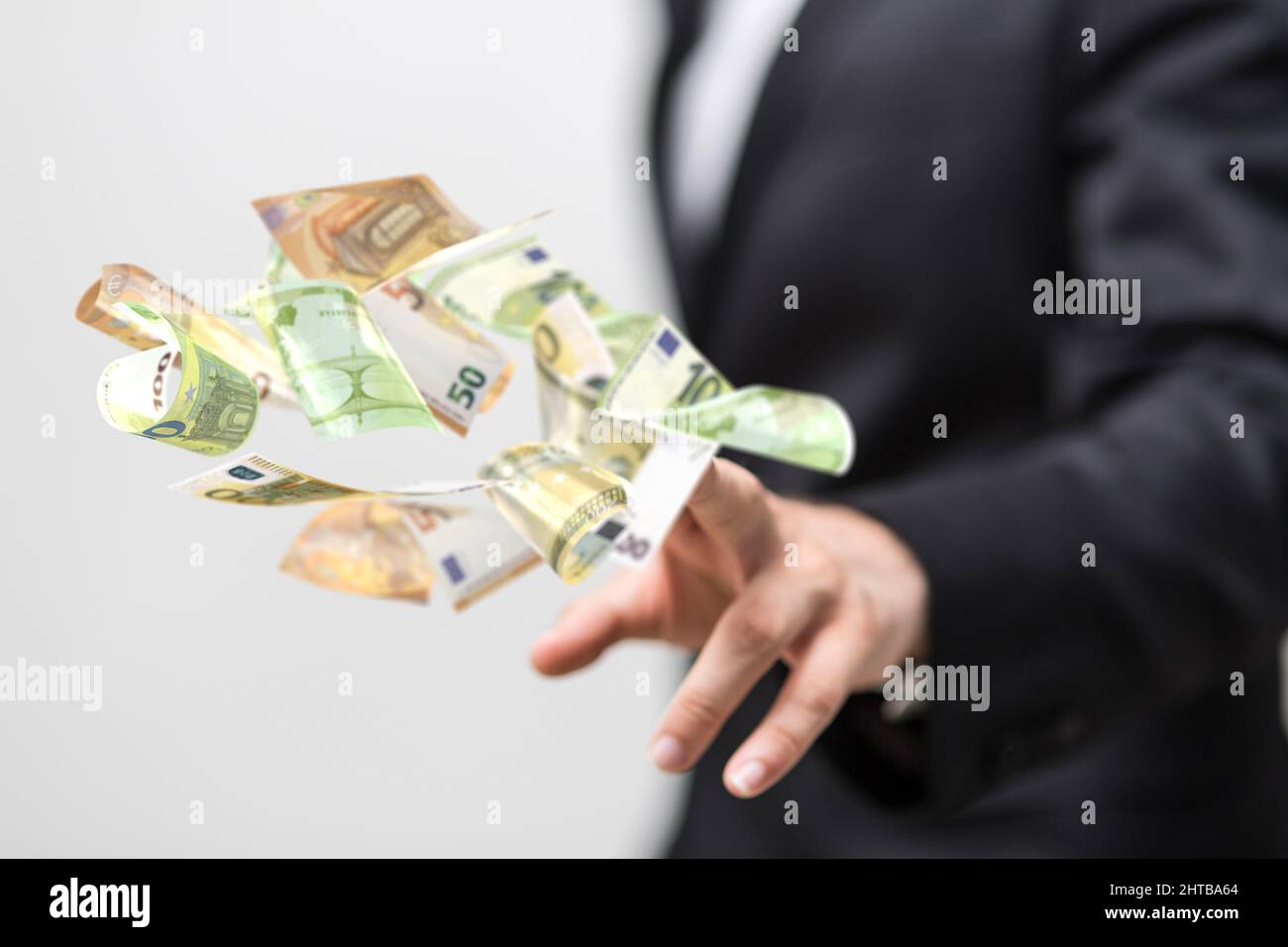 Illustration of euro bills flying around the hand Stock Photo - Alamy