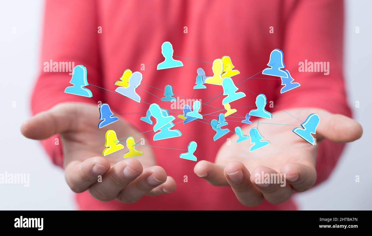 Shallow focus shot of human hands holding interconnected human icons ...