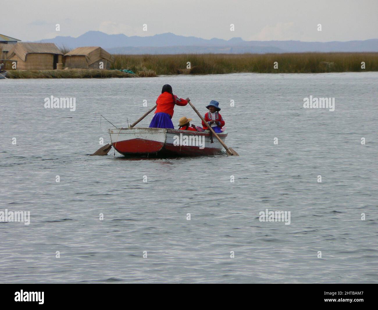 View of the school children rowing on the boat on Lake Titicaca, Peru ...