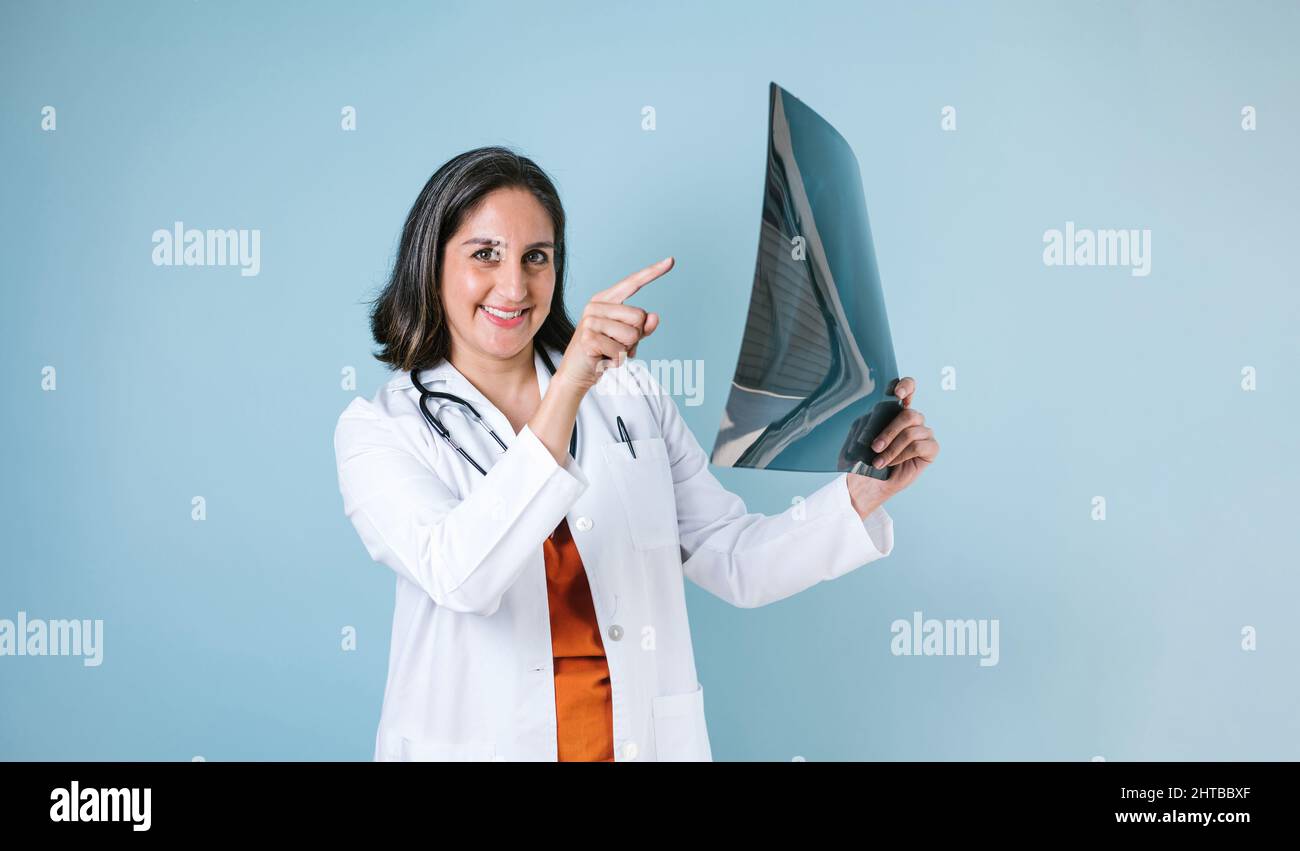 hispanic woman doctor looks at xray radiography images in radiology ...
