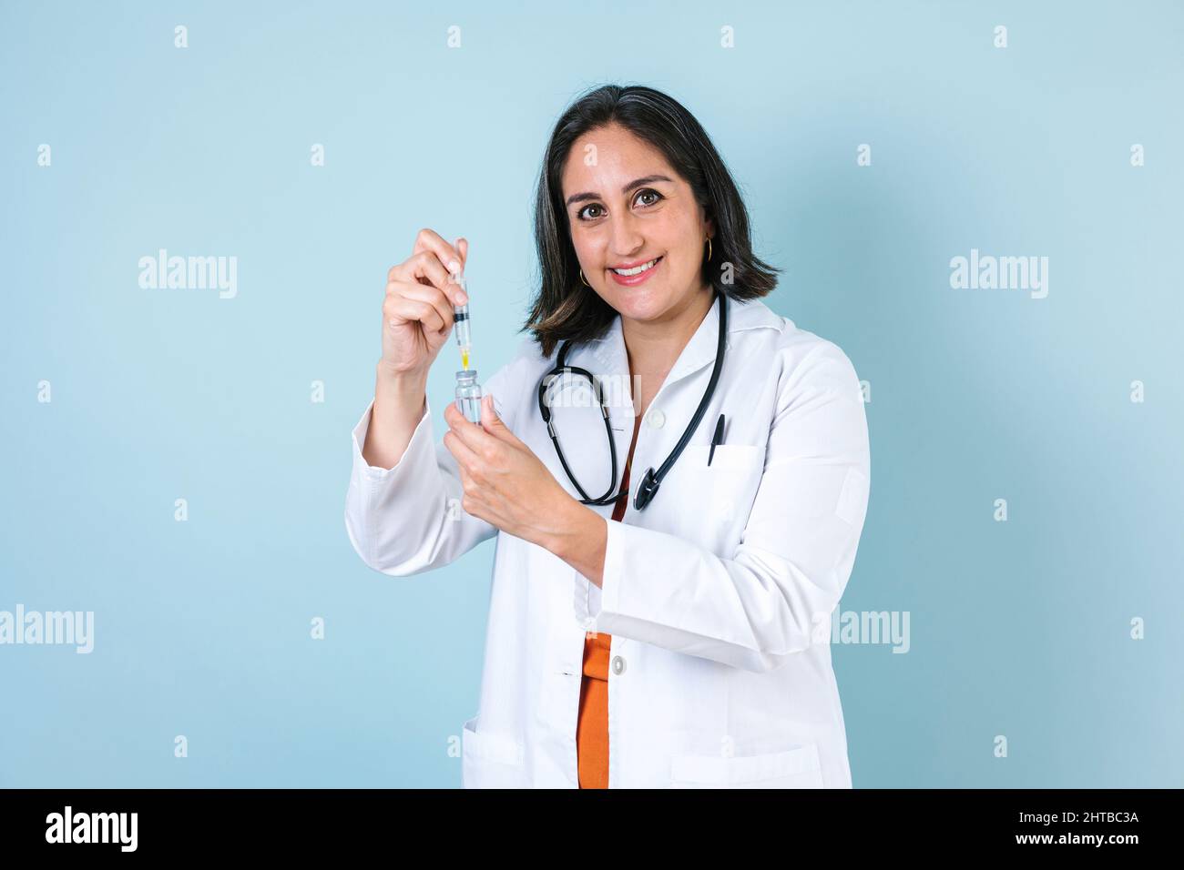 hispanic woman doctor holding vaccine injection in Mexico latin America ...