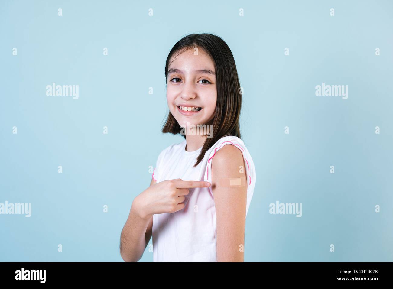 Hispanic girl child portrait after getting a vaccine protection and ...