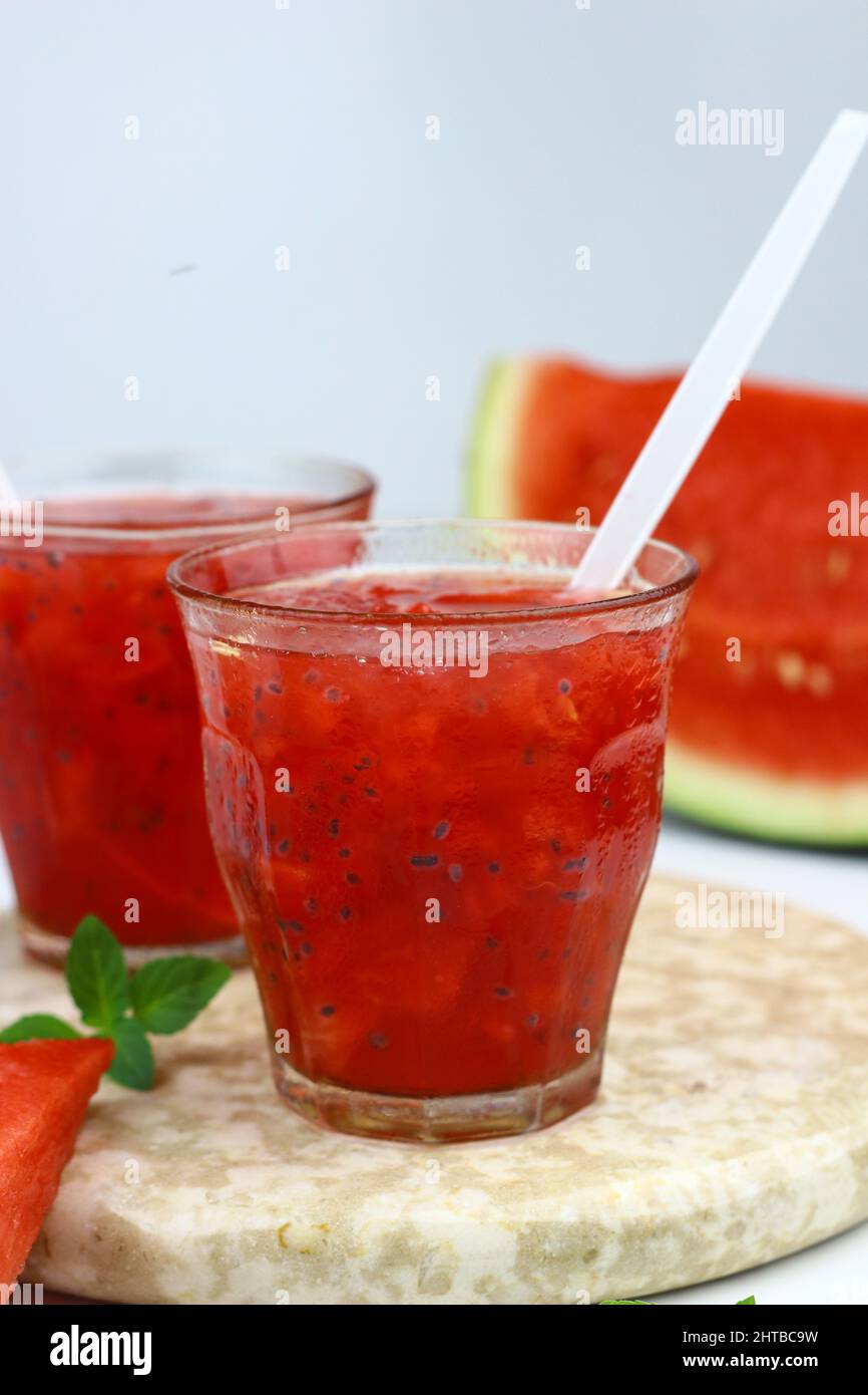 Watermelon ice drink served on clear glass on isolated white background ...