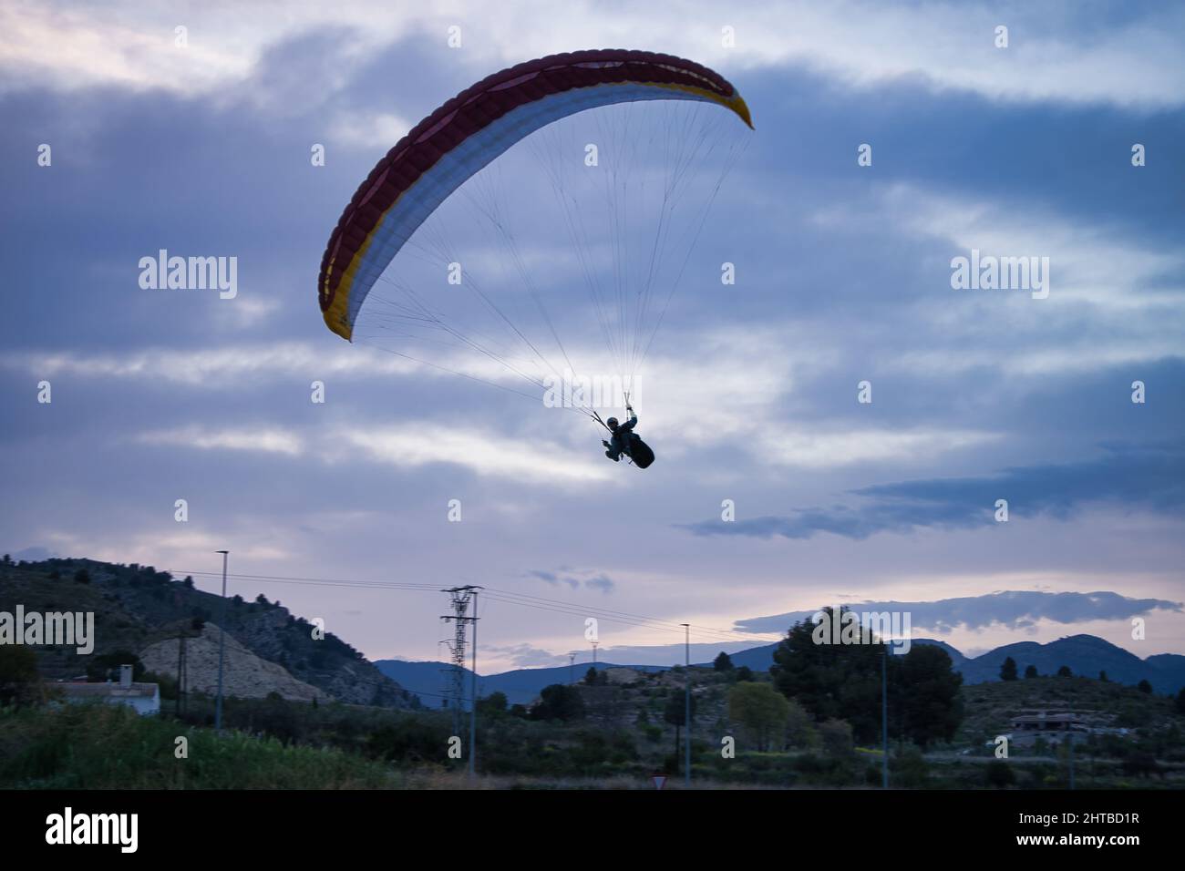 Shot of someone flying with parachute over mountain Stock Photo - Alamy