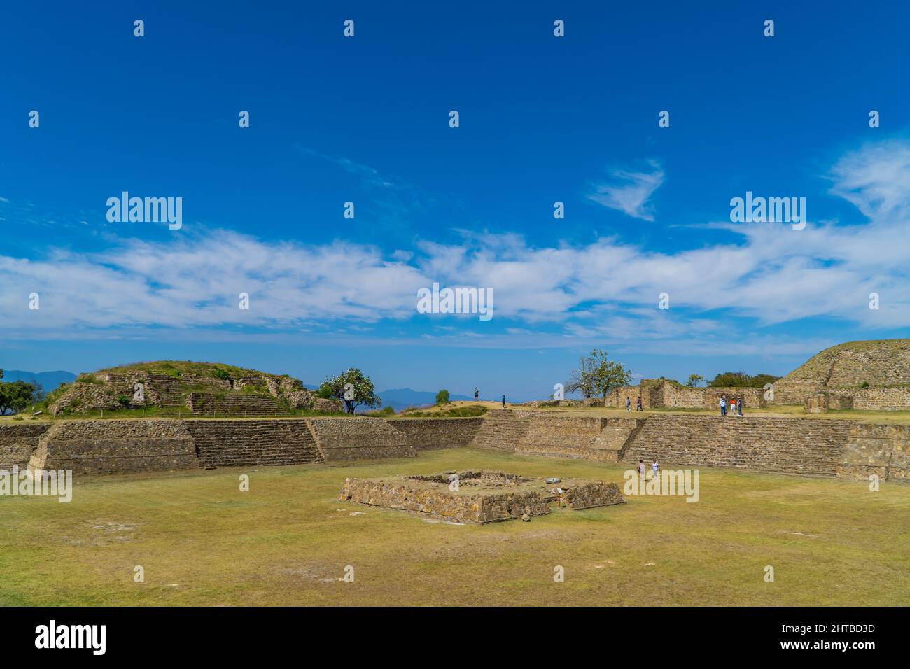 Zapotec temples with tourists inside the Monte Alban archaeological ...