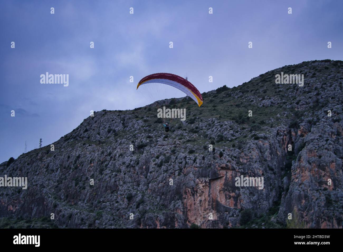 Shot of someone flying with parachute over mountain Stock Photo - Alamy