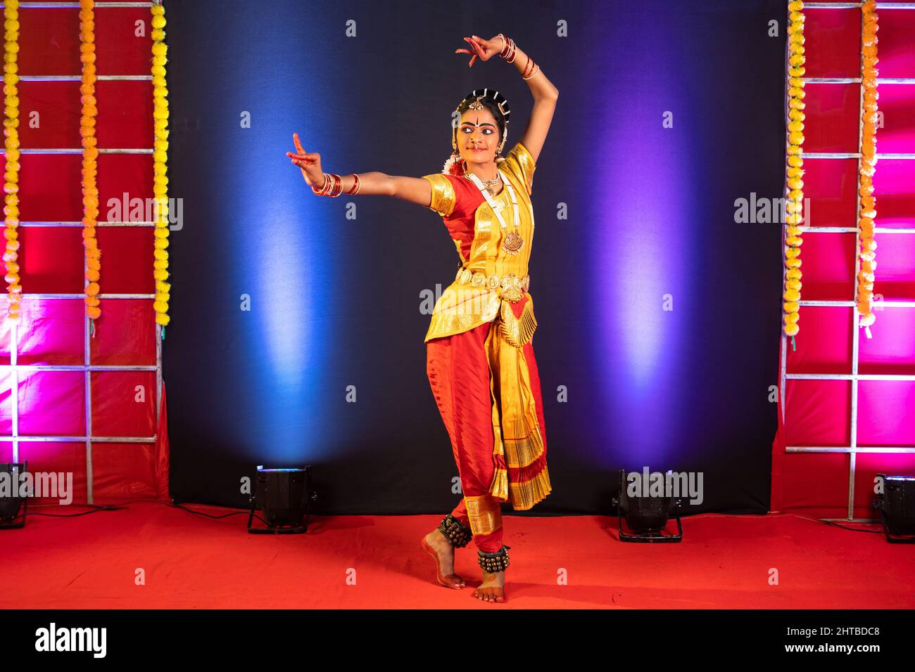 Full shot of Bharatnatyam dancer performing on stage - conept of ...
