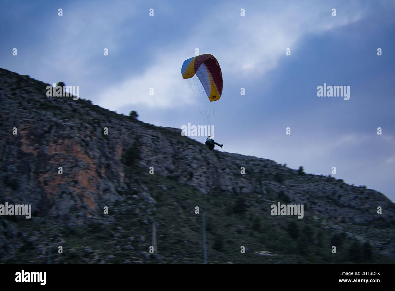 Shot of someone flying with parachute over mountain Stock Photo - Alamy