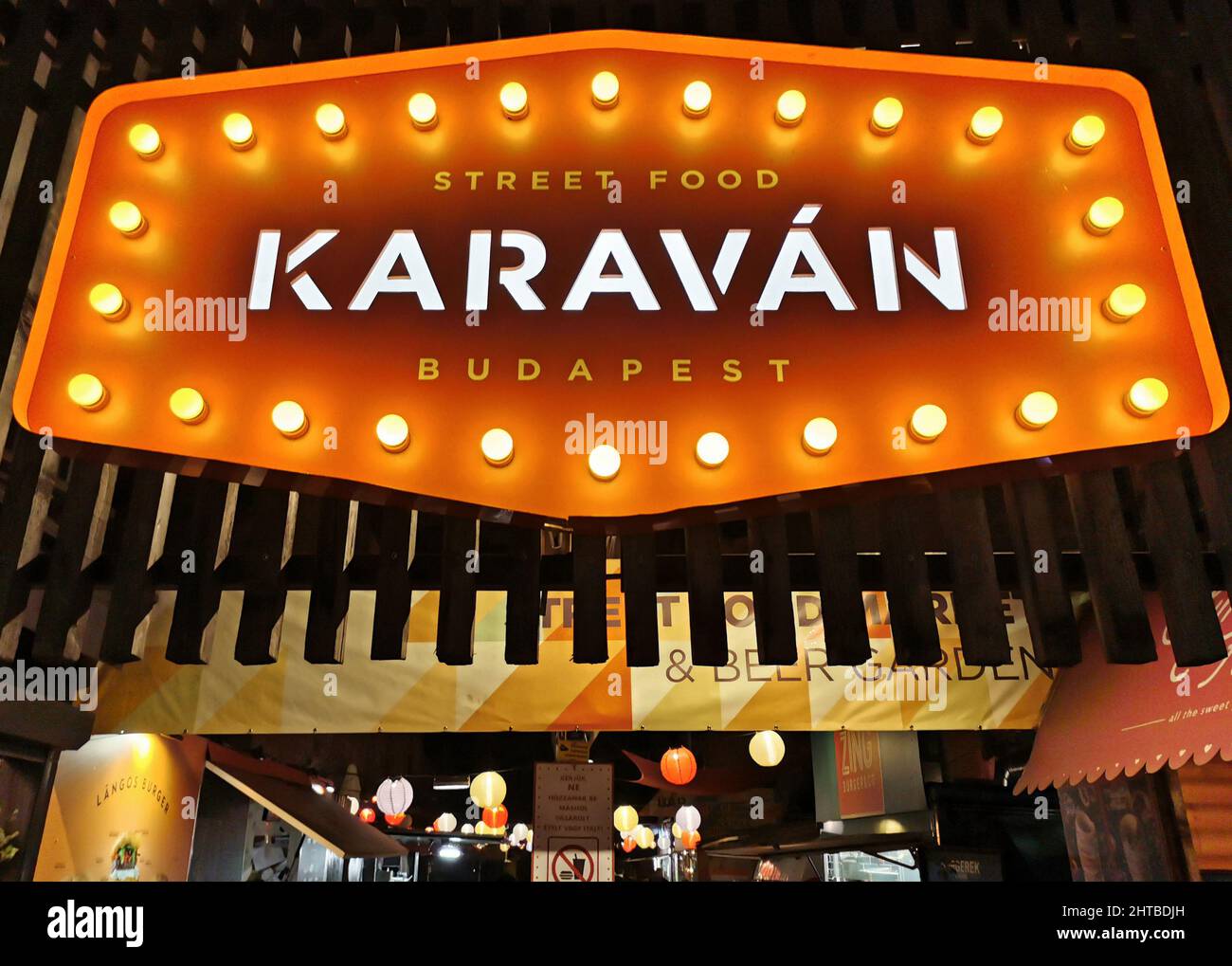 Orange sign above the entrance to street food Karavan in Budapest ...