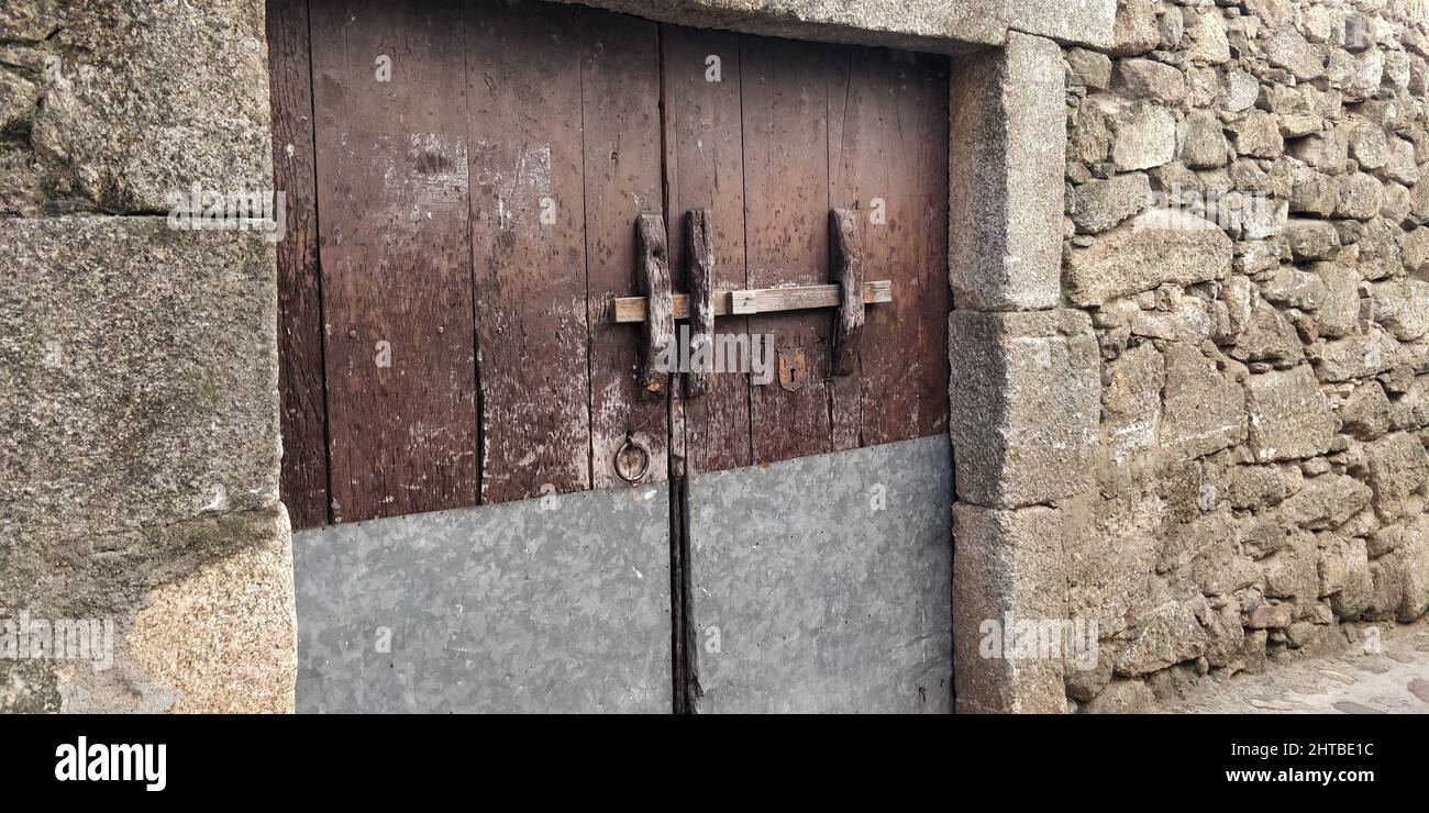 Very old gate with lock in a wall made from big rocks Stock Photo - Alamy
