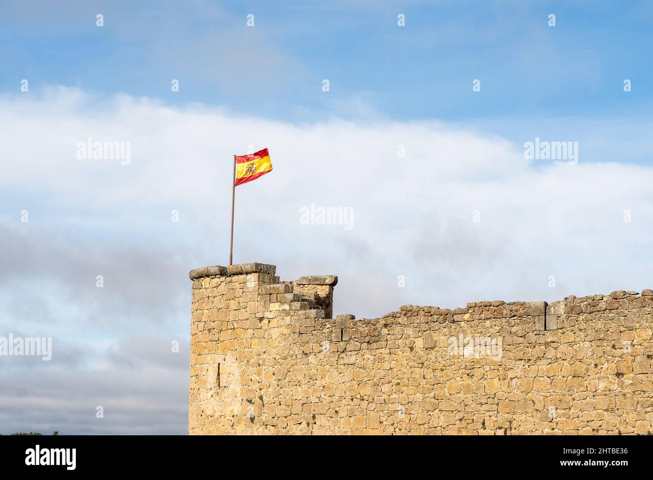 Spanish flag over an ancient building Stock Photo - Alamy