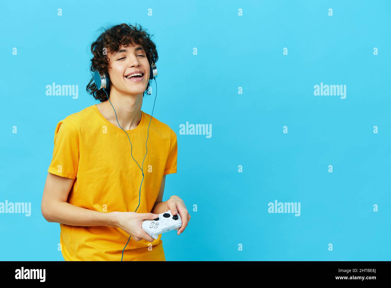 gamer yellow T-shirt with joystick video games isolated backgrounds ...