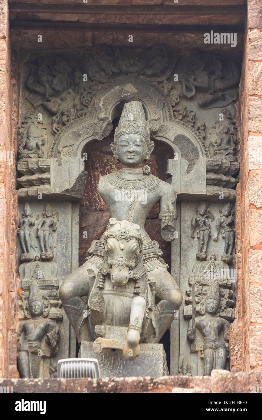 Statue of Vedic Sun god Surya or Arka in mellow mood carved on the wall ...