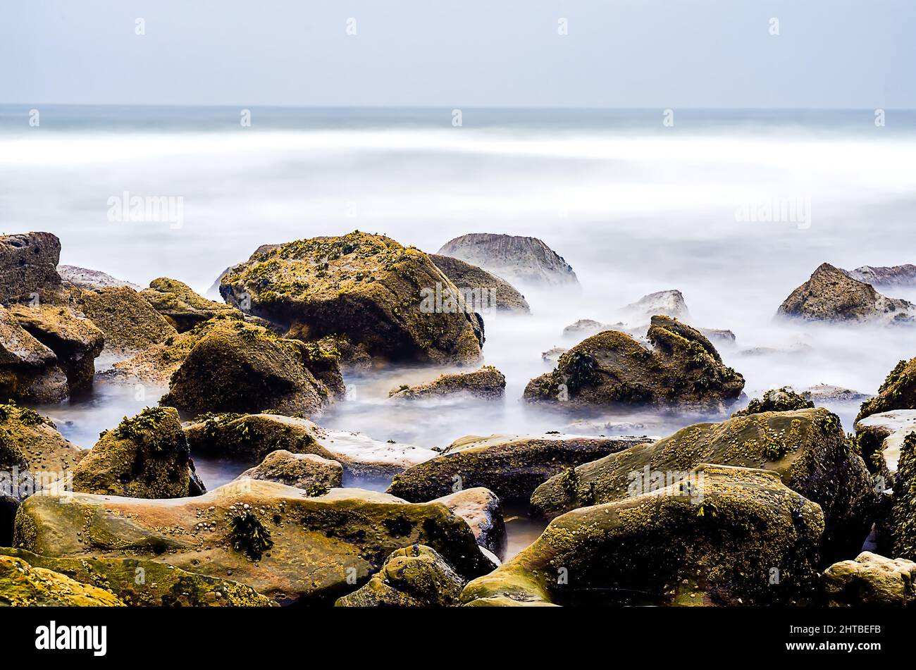 Ocean landscape with a rocky beach and neutral density filter with wide ...