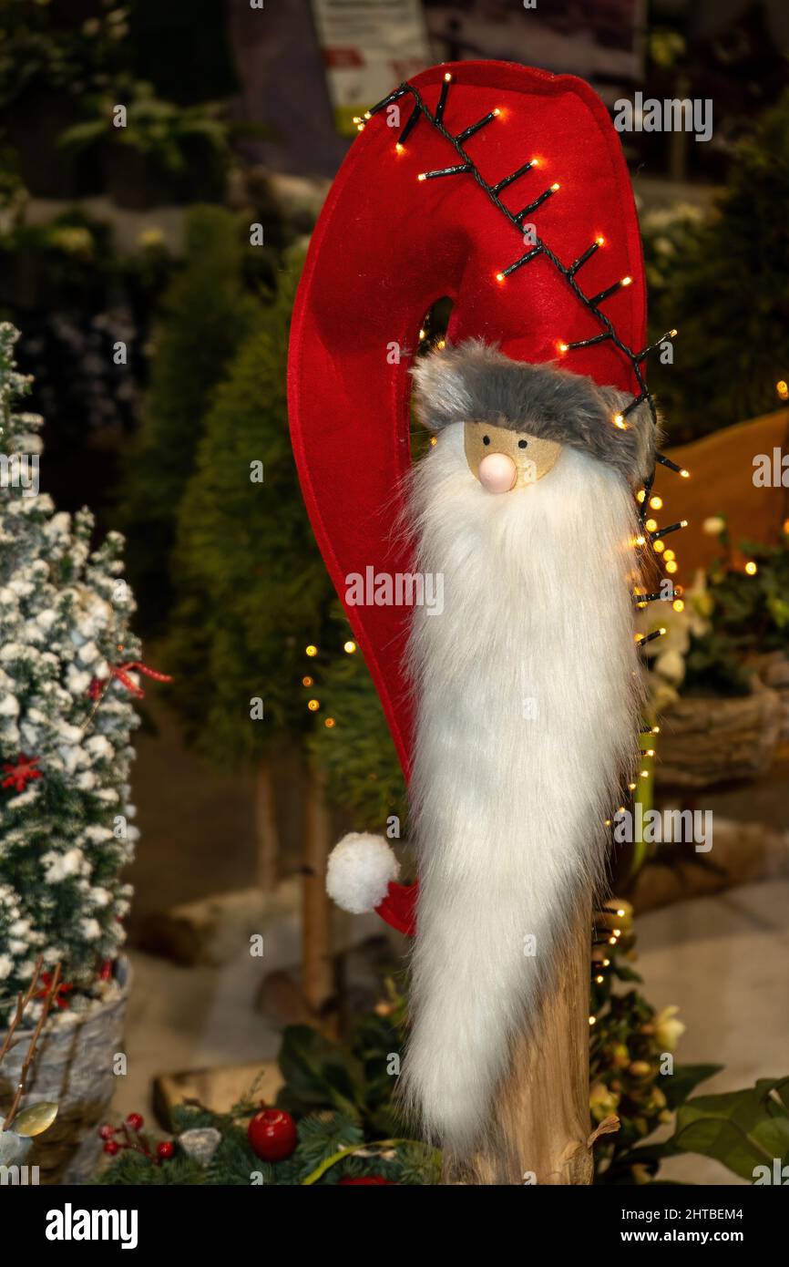 Vertical shot of a Santa Clause toy with a long beard and a long hat ...