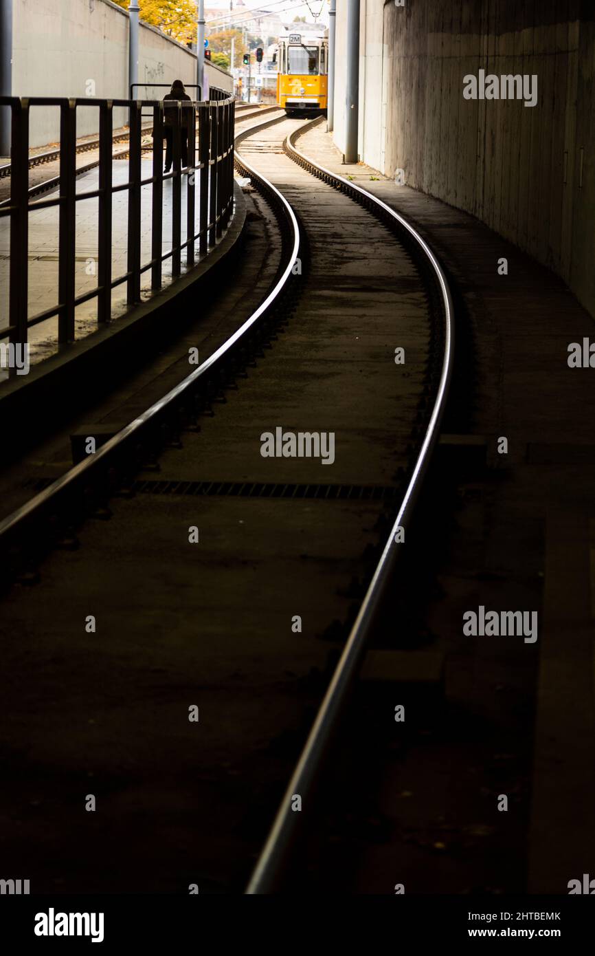 Vertical shot of an old railroad of a yellow tram in a city Stock Photo ...