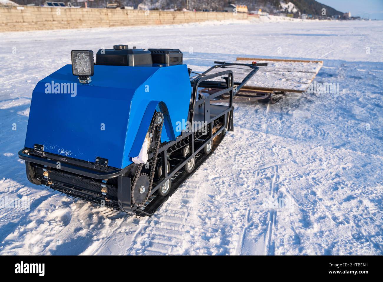 Tractor with a trailer on the ice of Lake Baikal Stock Photo - Alamy