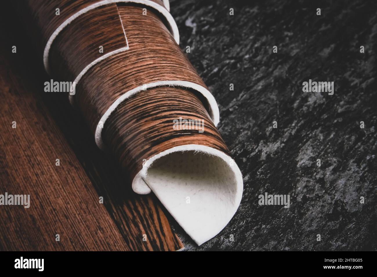 Linoleum. Roll of linoleum on a black background. Floor coverings ...