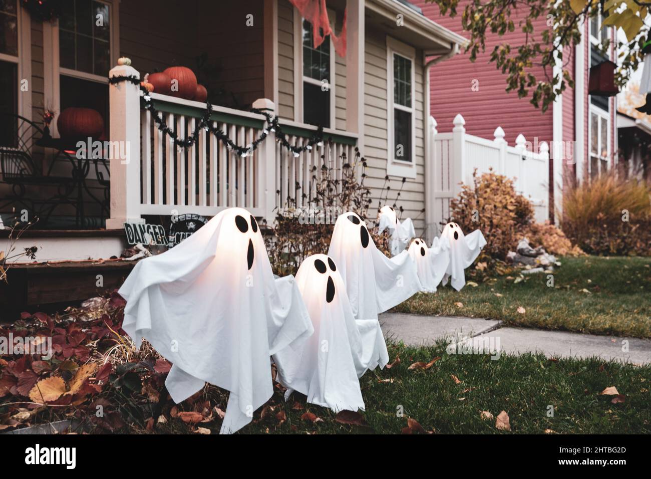 House exterior decorated with ghosts on foliage leaves ready for ...