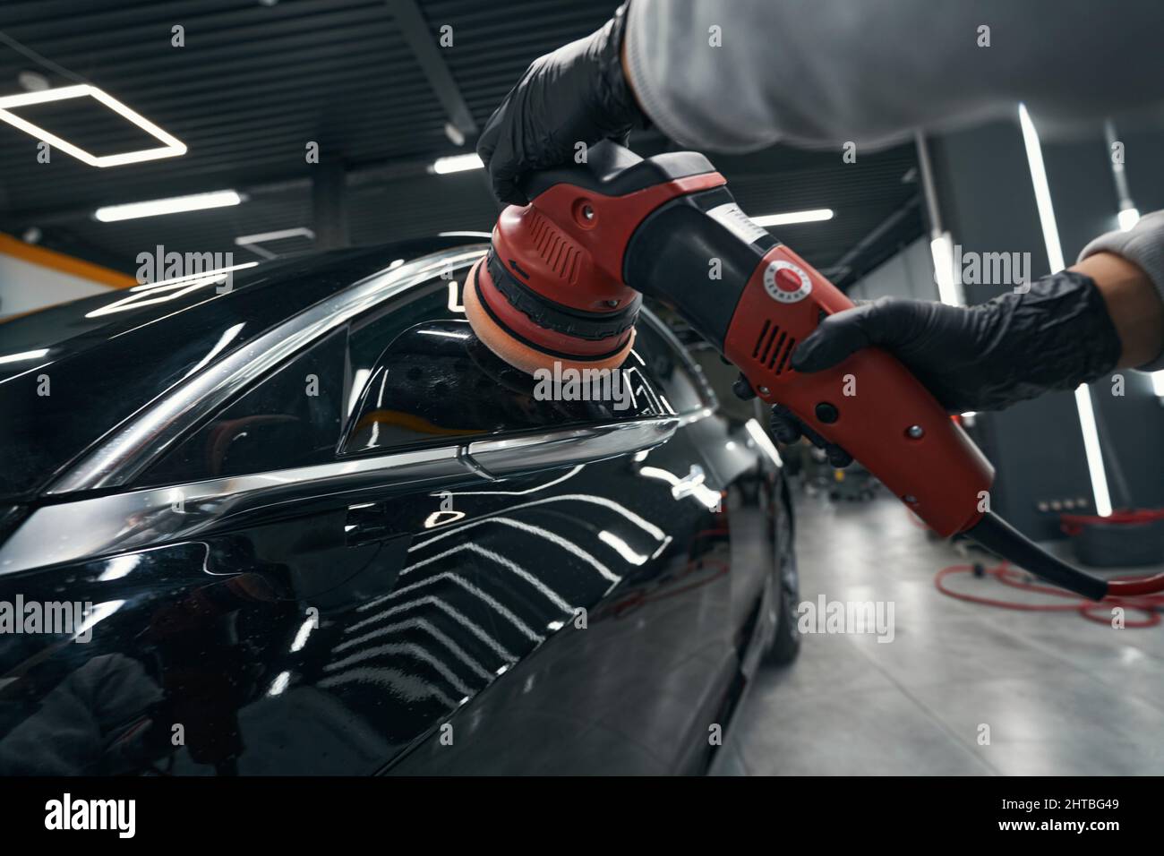 Experienced service station worker using buffing machine Stock Photo ...