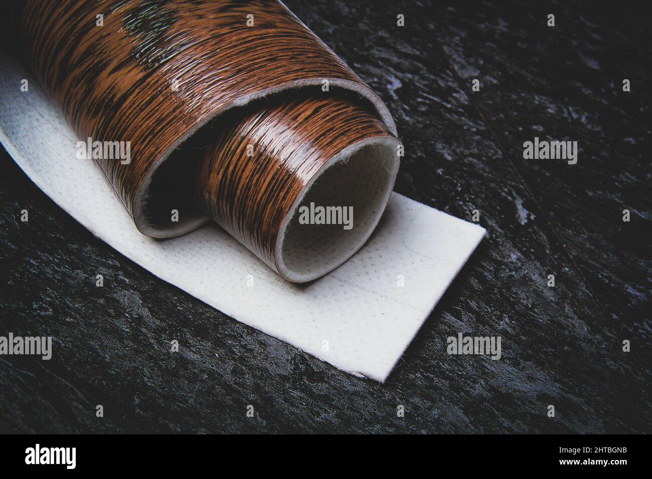 Linoleum. Roll of linoleum on a black background. Floor coverings ...