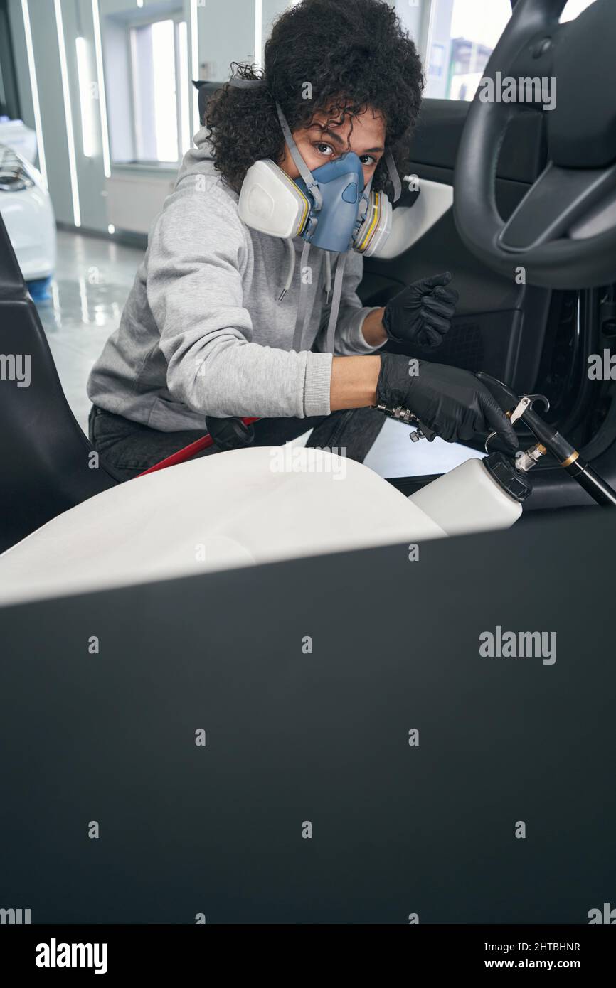 Female auto detailer posing for camera during car detailing Stock Photo ...