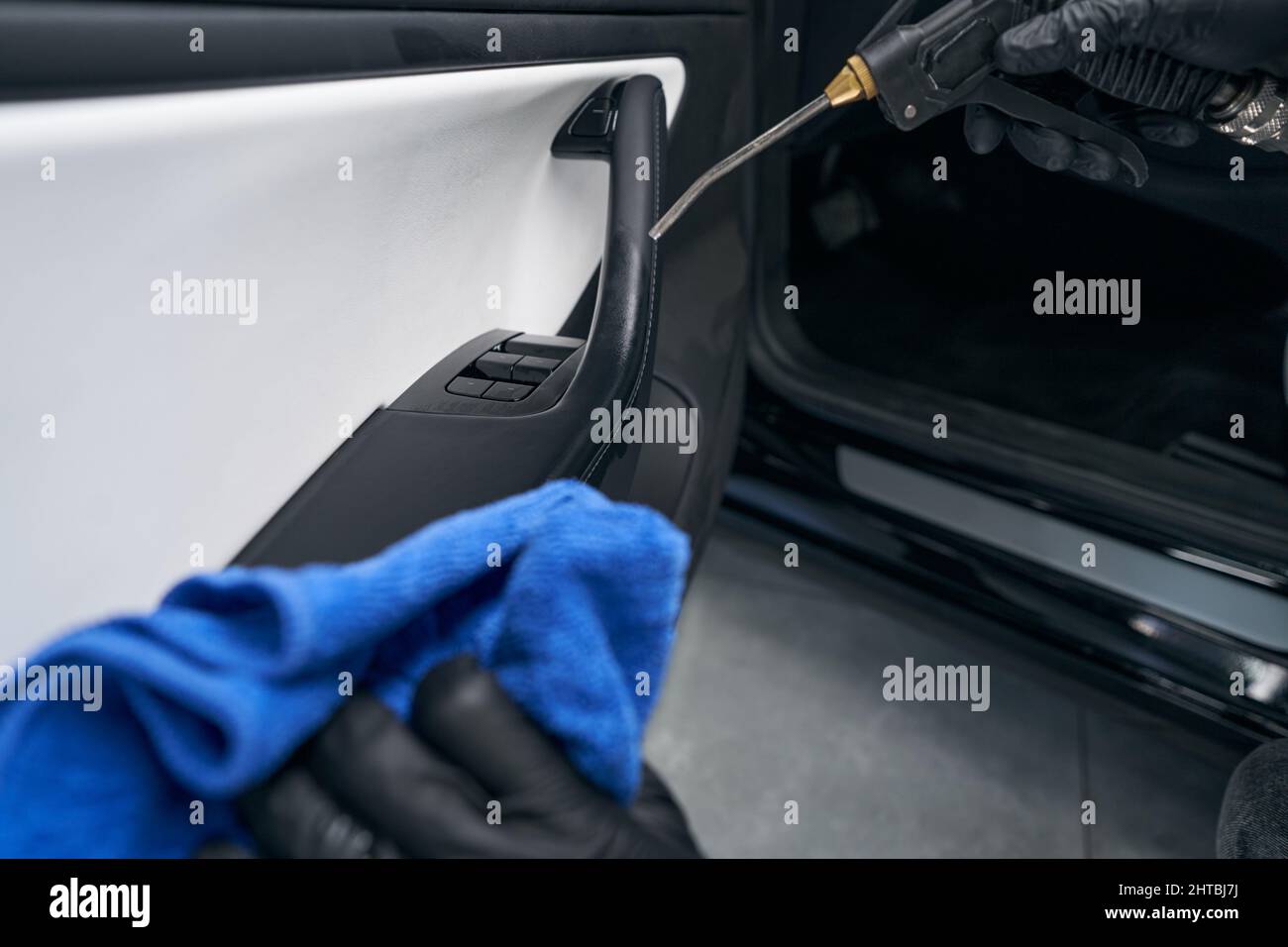 Professional using pneumatic tool during auto detailing Stock Photo - Alamy