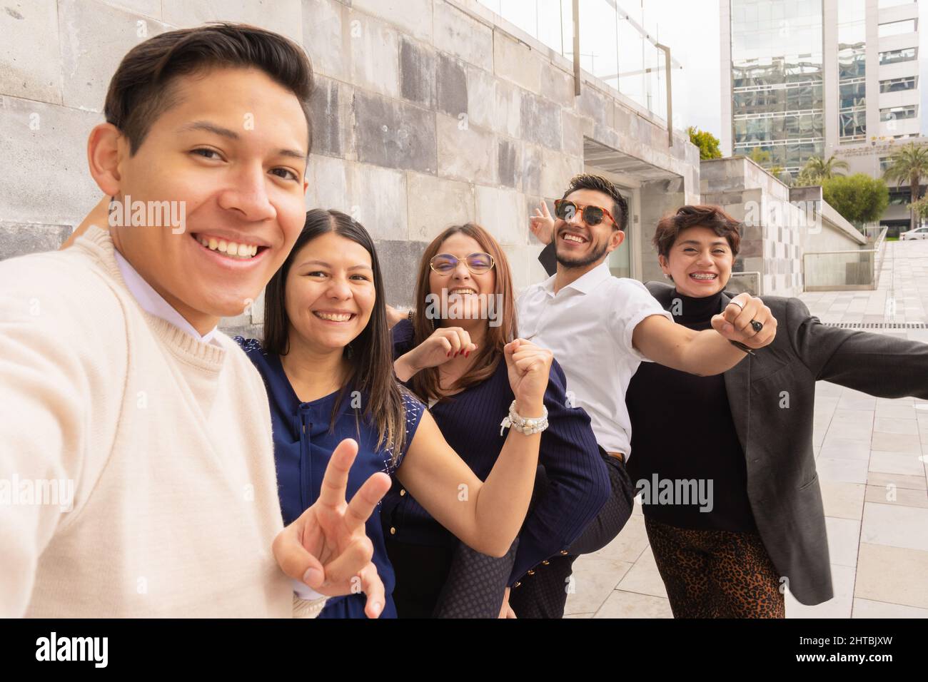 Closeup of Co-workers leaving the office and talking together about ...