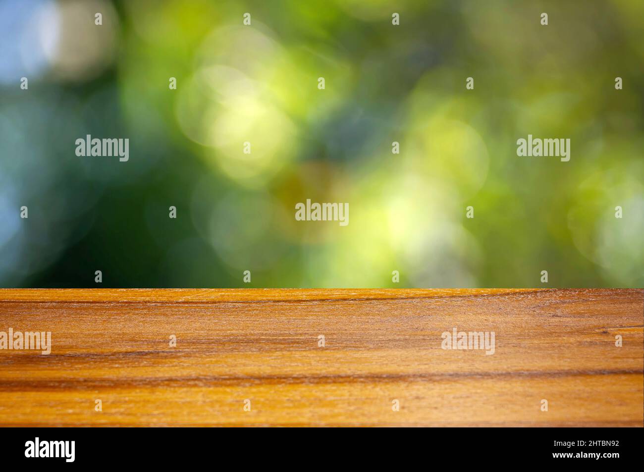 Wooden board empty table in front of green bokeh background for display ...