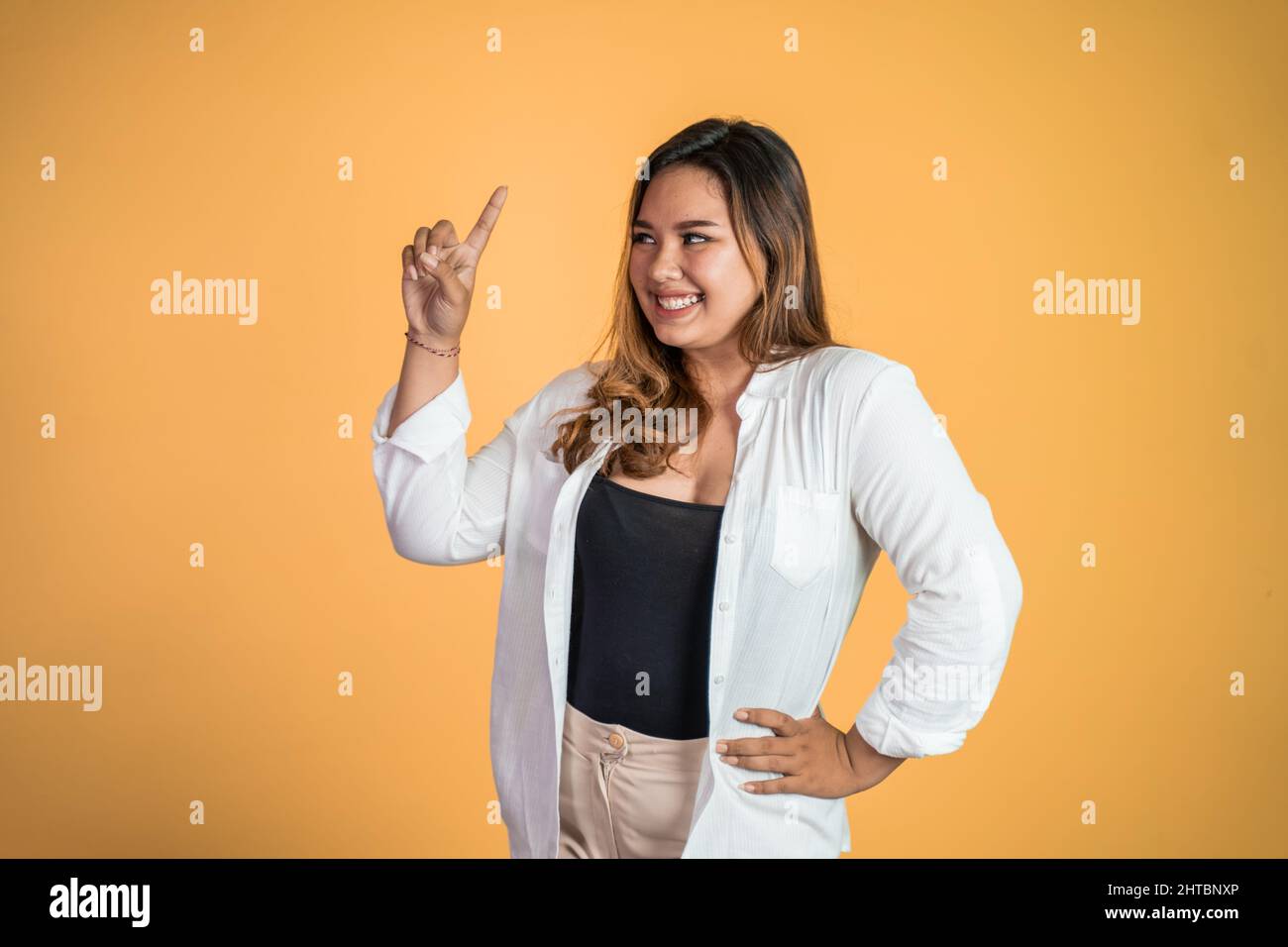 attractive asian woman with finger pointing up hand gesture Stock Photo ...
