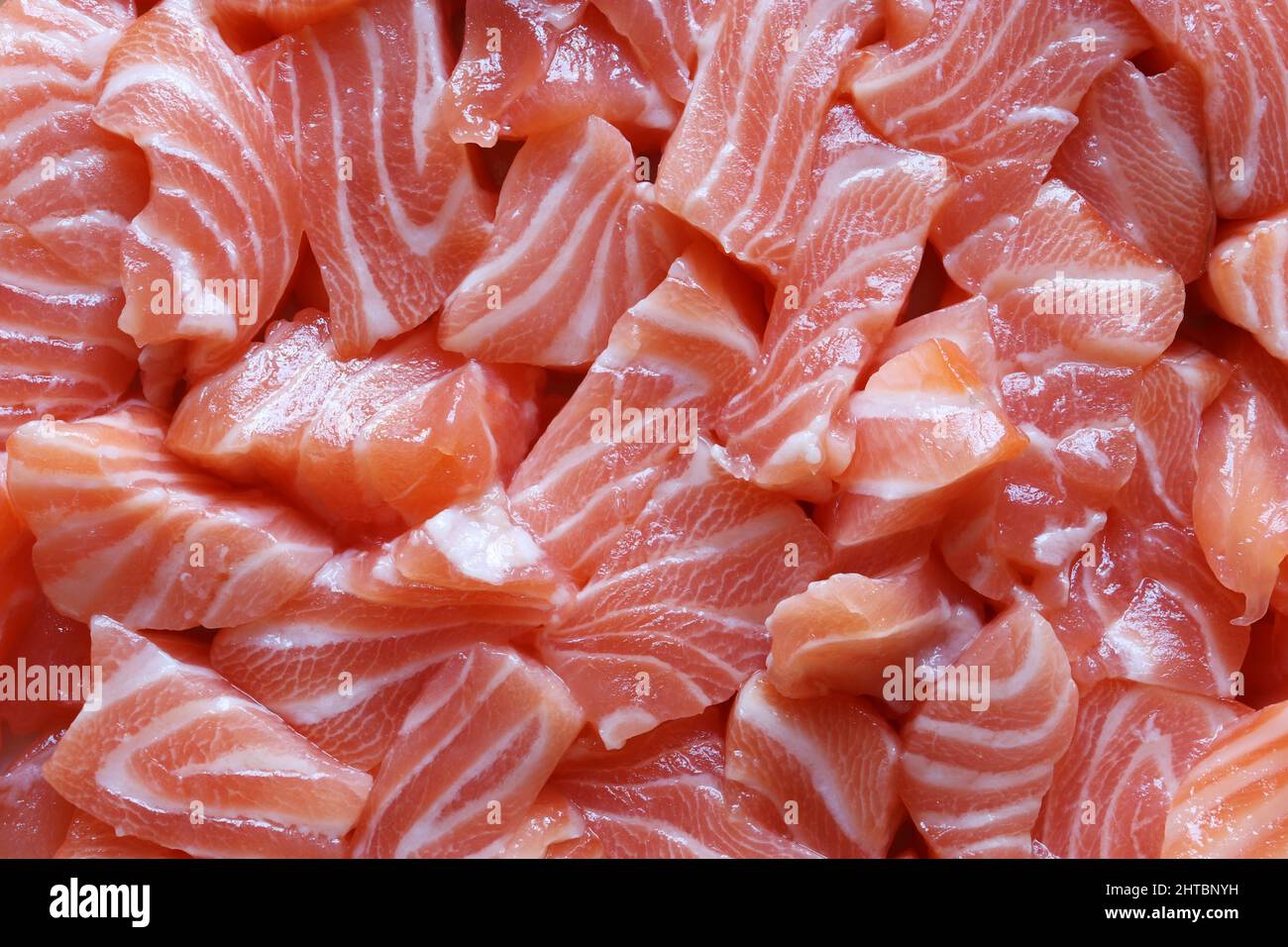 Closeup of salmon fillet cut into small pieces Stock Photo - Alamy