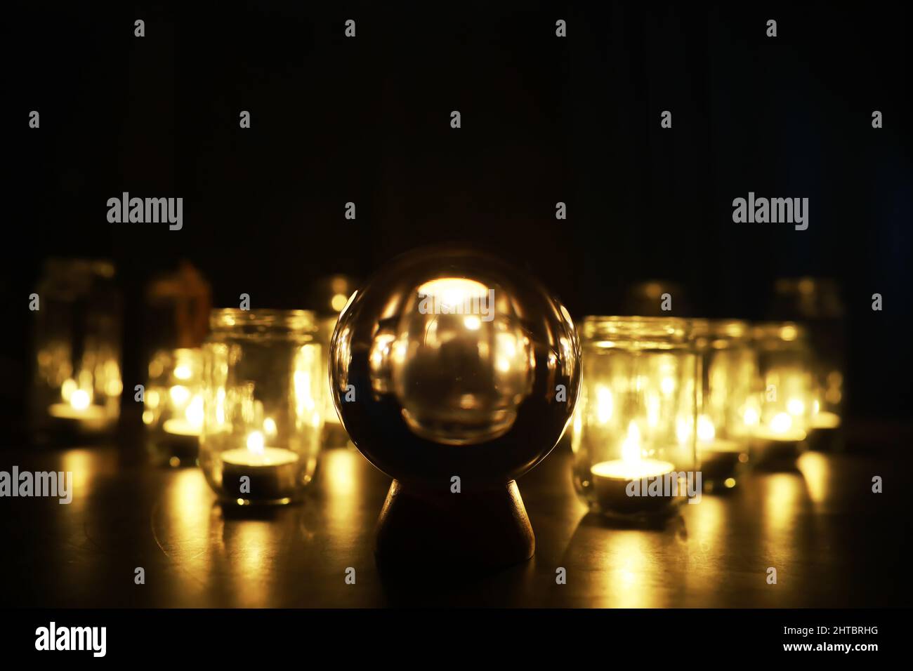Black background with ball and candles. Divination and prediction of ...
