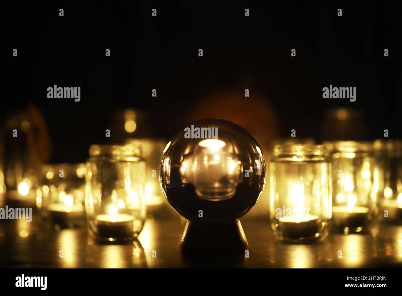 Black background with ball and candles. Divination and prediction of ...